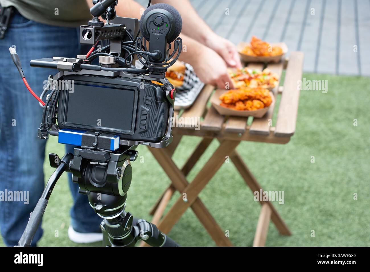 A view of a video camera in front of a patio table of American street ...