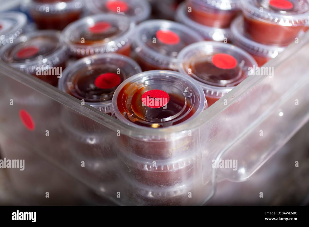 A view of a bucket full of plastic sauce condiment cups Stock Photo - Alamy