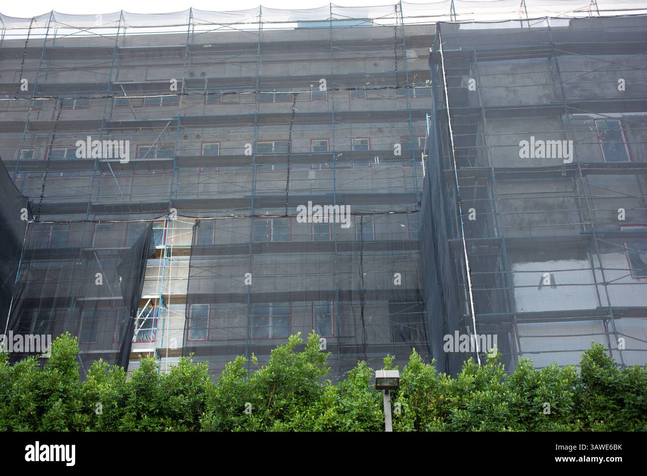 A view of a netted scaffold structure surround a building during ...