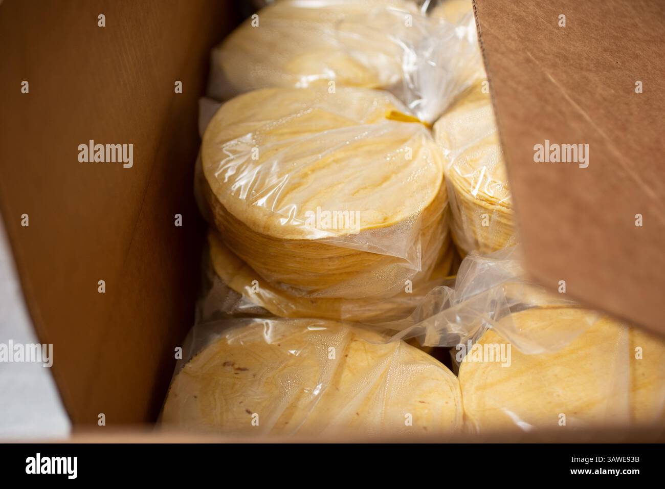 A view inside a large cardboard box, full of packages of freshly made ...