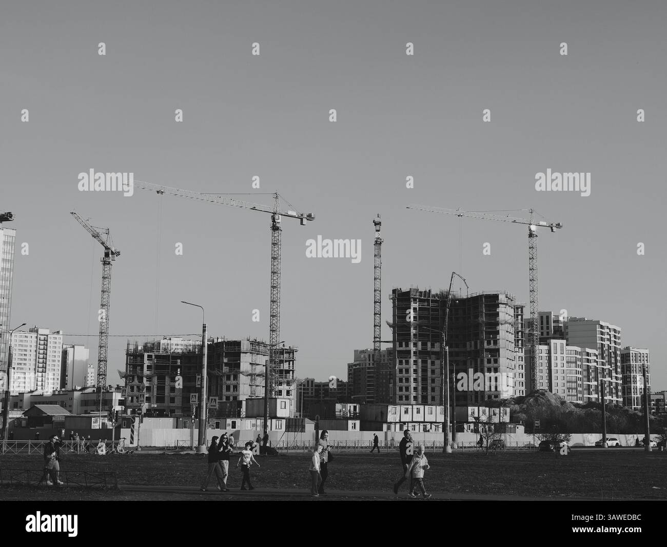 A Detailed Urban Construction Scene Featuring Cranes and Workers ...