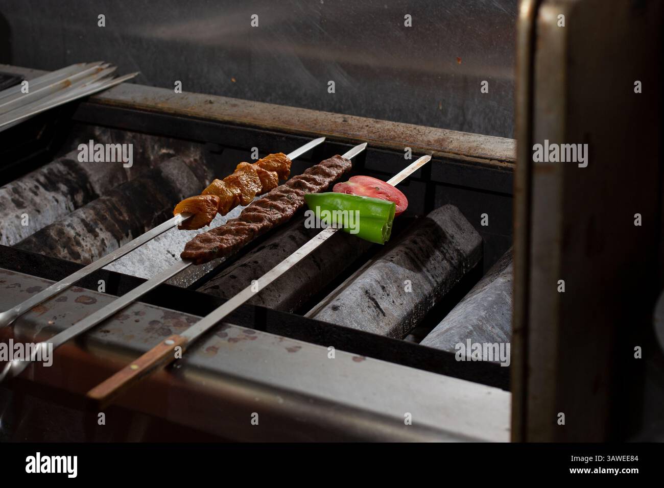 A view of middle eastern grill, featuring food items on large metal ...