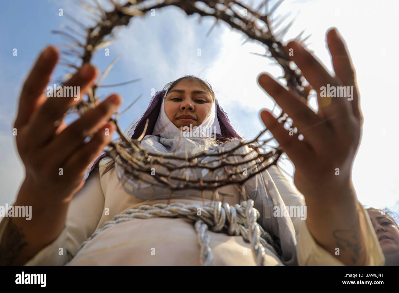 An actress holds the crown of thorns during the passion of Christ in ...