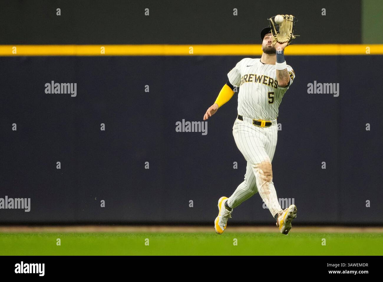 Milwaukee Brewers' Garrett Mitchell catches a fly ball during the ...