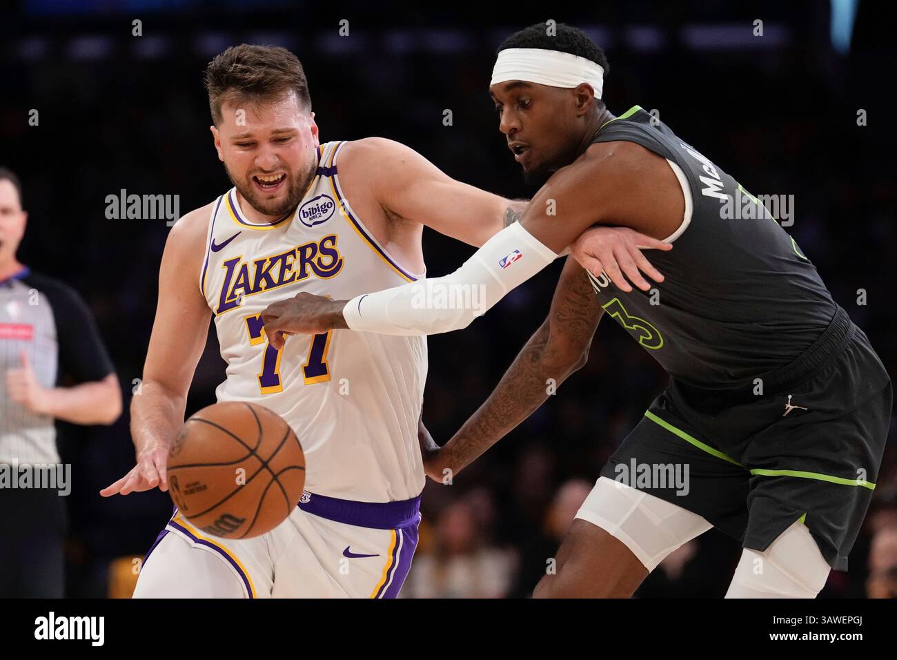 Minnesota Timberwolves forward Jaden McDaniels, right, reaches in on ...