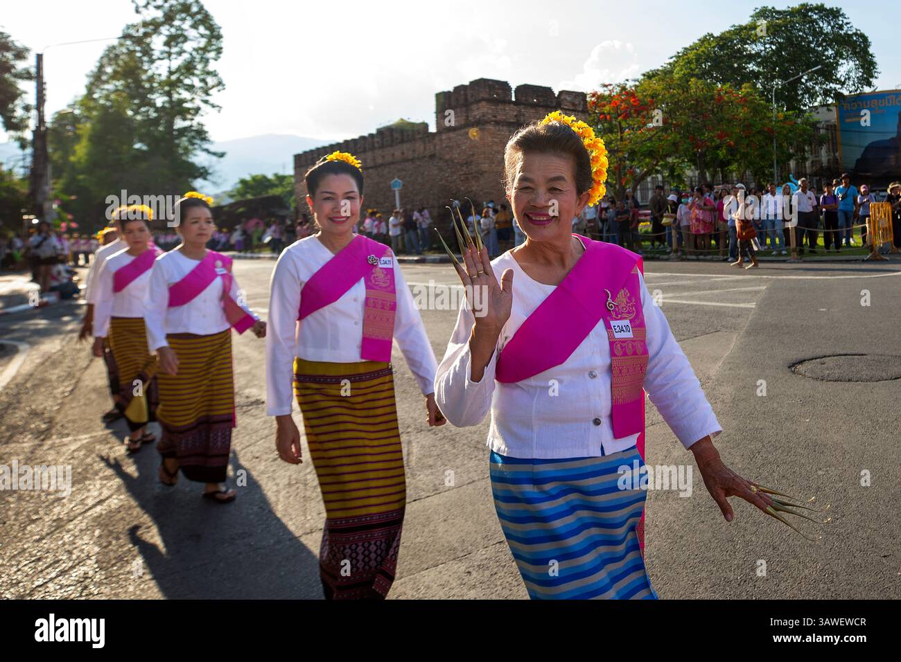 A Thai dancer is seen waving to greet others while preparing to perform ...