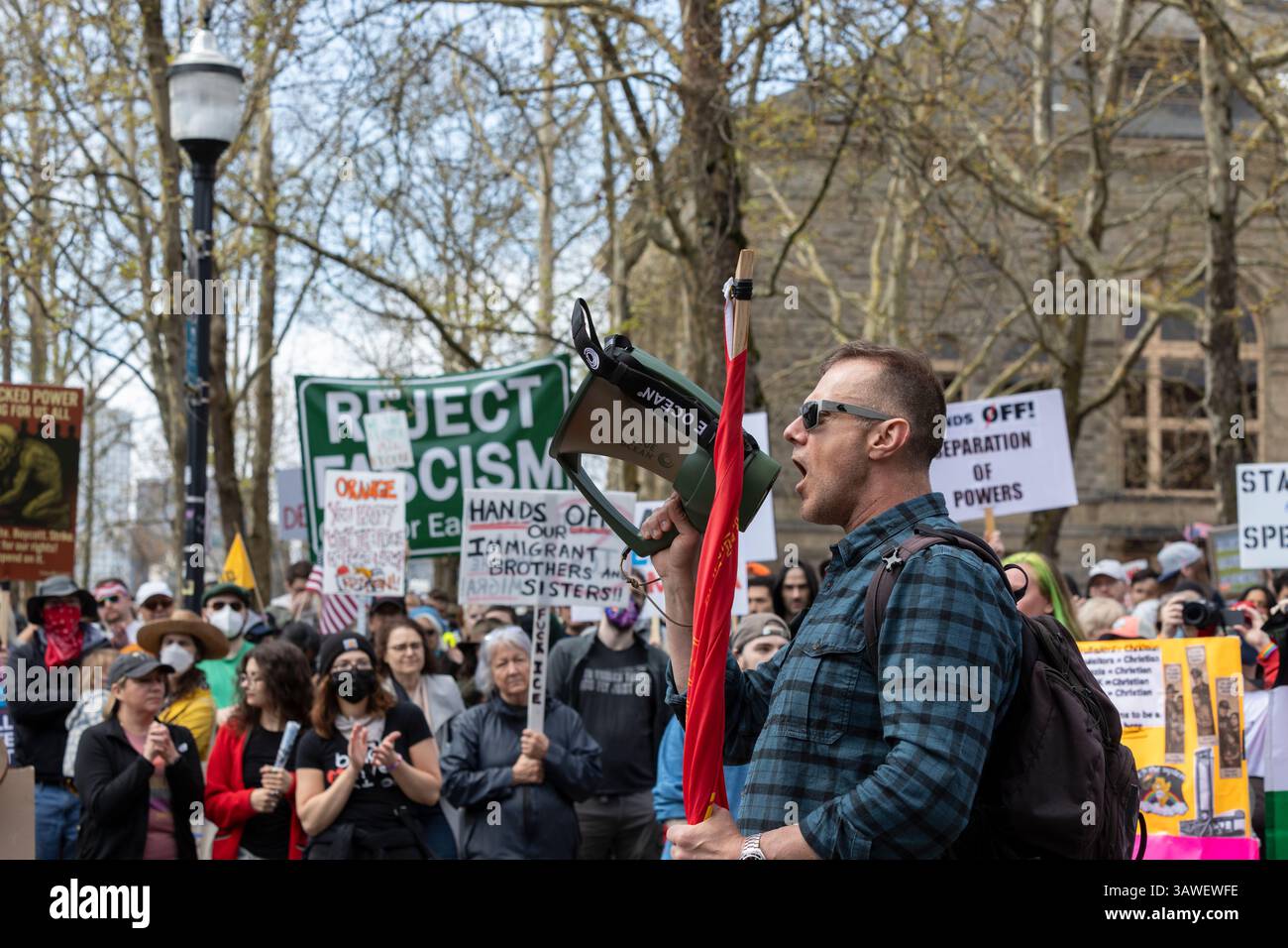 Seattle, Washington, USA. 19th April 2025. A man speaks to protesters ...