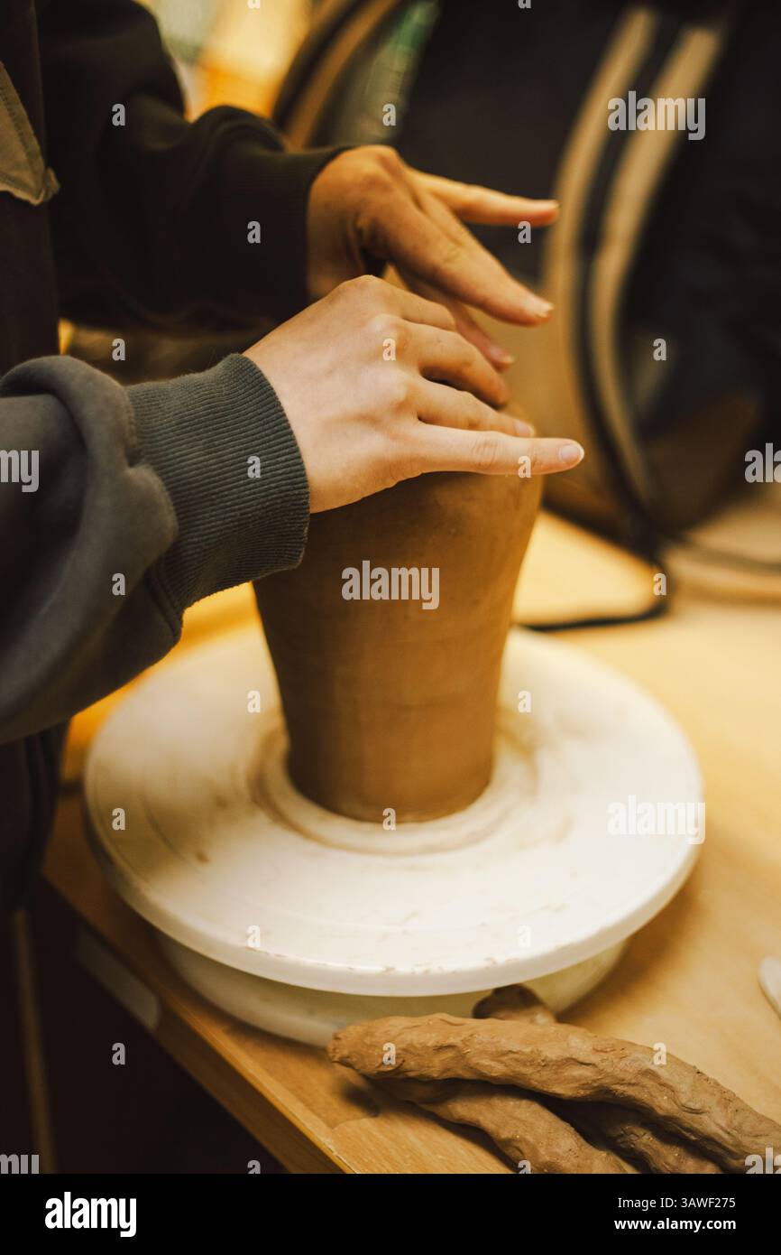 Hands skillfully shape a clay pot in a pottery studio Stock Photo - Alamy