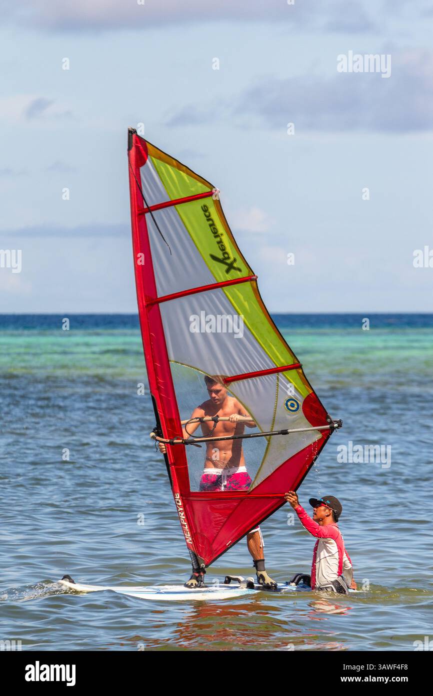 A man learns how to windsurf at Bulabog Beach in Boracay Island ...