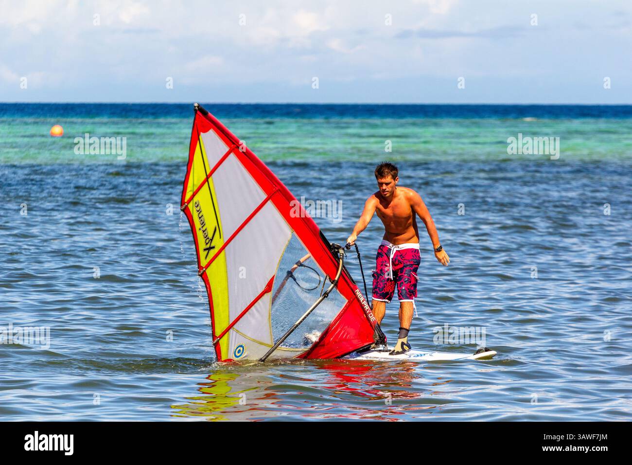 A man learns how to windsurf at Bulabog Beach in Boracay Island ...