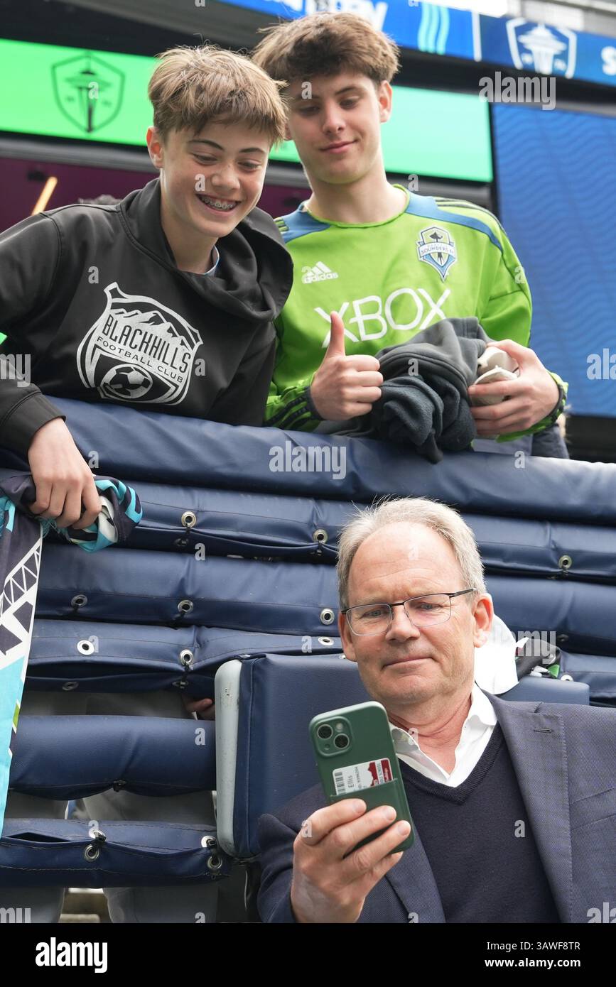 Seattle Sounders FC head coach Brian Schmetzer takes a photo with fans ...
