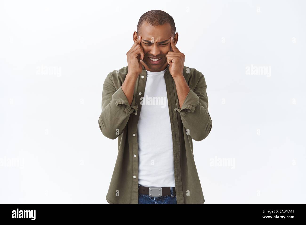Portrait of young depressed or sick african-american man, feeling severe headache, suffer ...