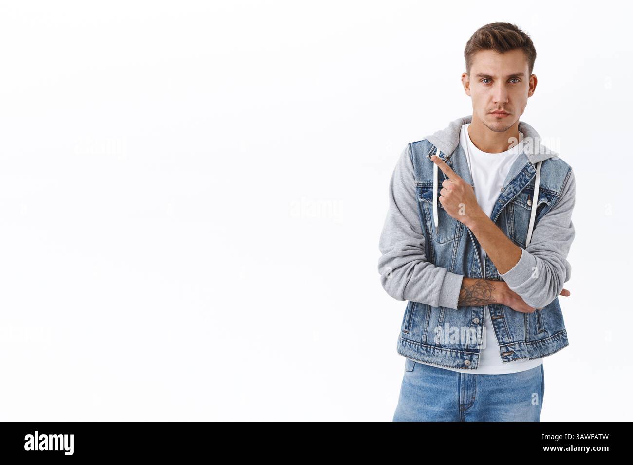 Serious-looking confident young slim tall guy with blond hair, look ...