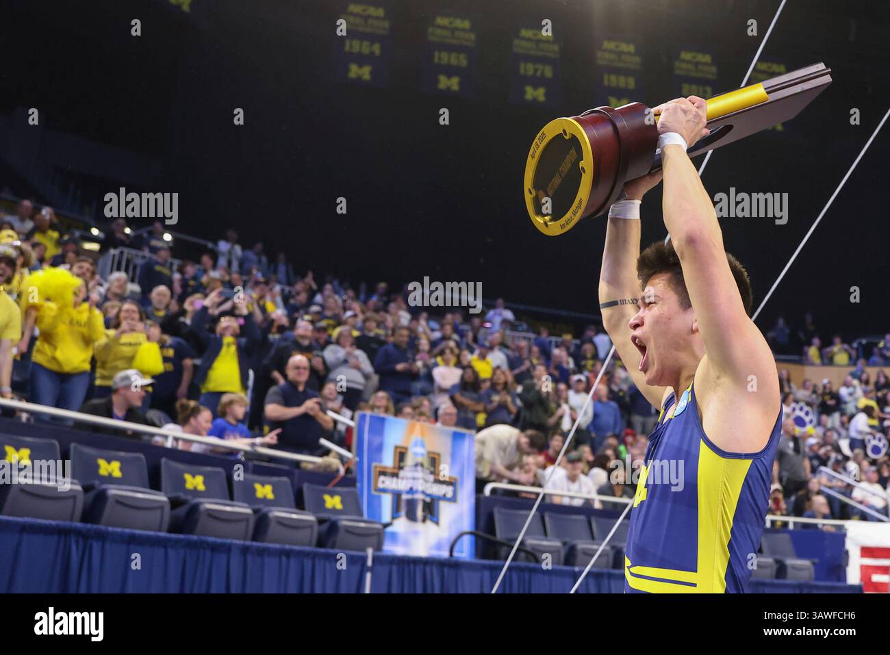 ANN ARBOR, MI - APRIL 19: Michigan gymnast David Wolma hoists the ...