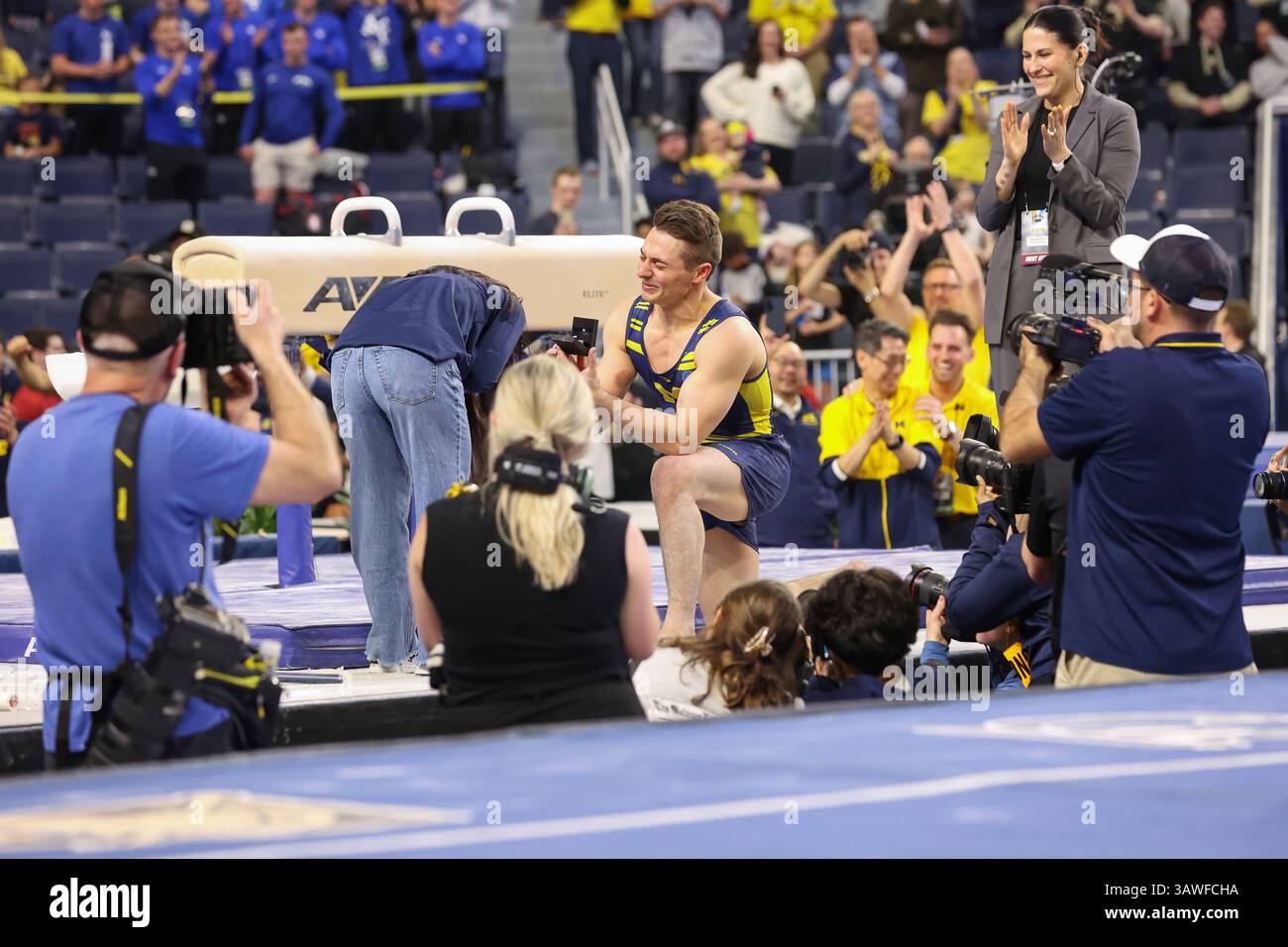 ANN ARBOR, MI - APRIL 19: Michigan gymnast Paul Juda, right, kneels ...