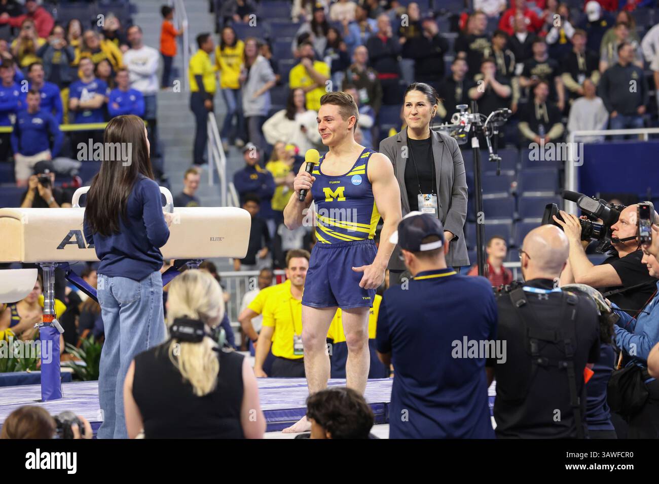 ANN ARBOR, MI - APRIL 19: Michigan gymnast Paul Juda, right, proposes ...