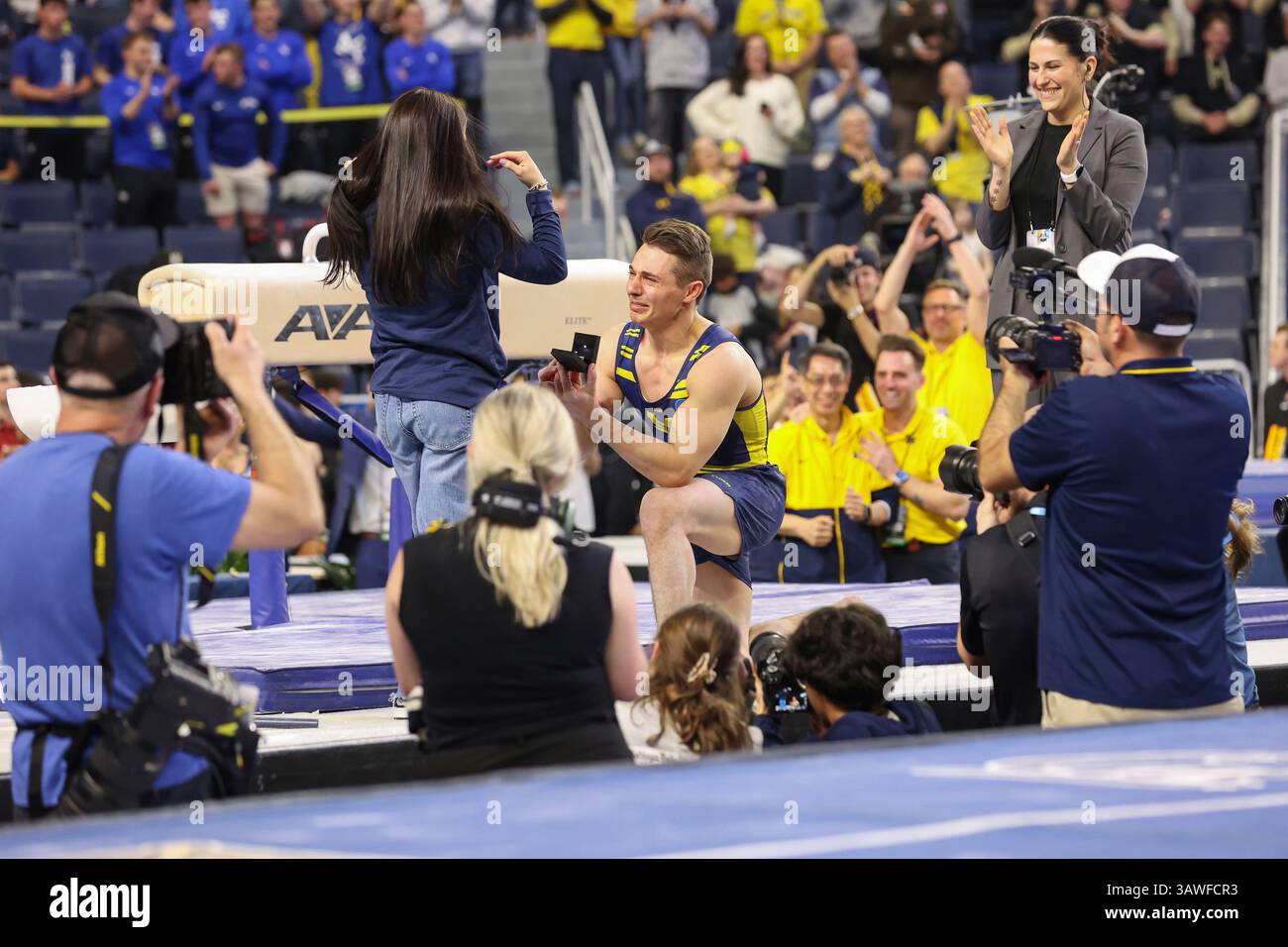 ANN ARBOR, MI - APRIL 19: Michigan gymnast Paul Juda, right, kneels ...