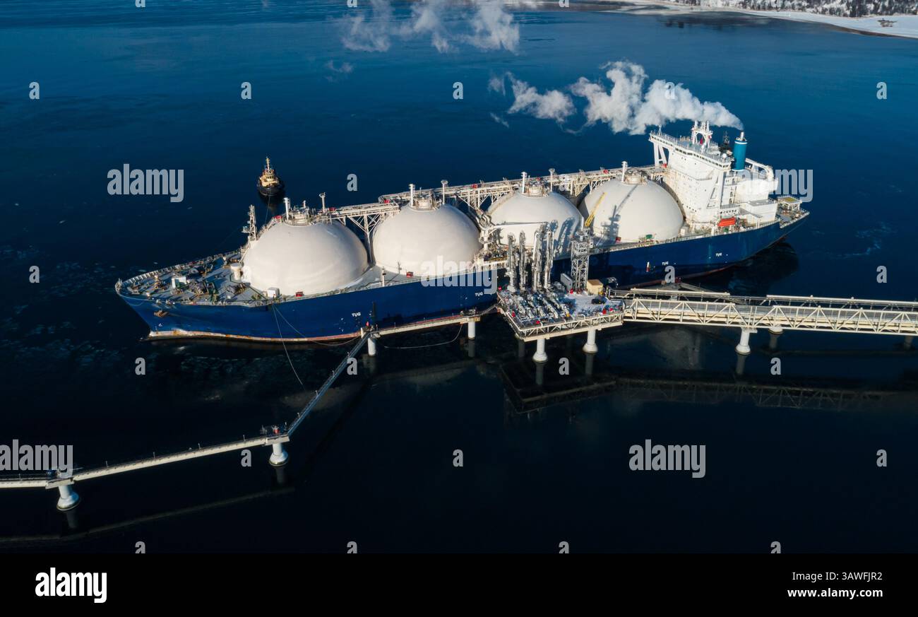 Aerial of Liquified Natural Gas LNG carrier moored to a small gas ...