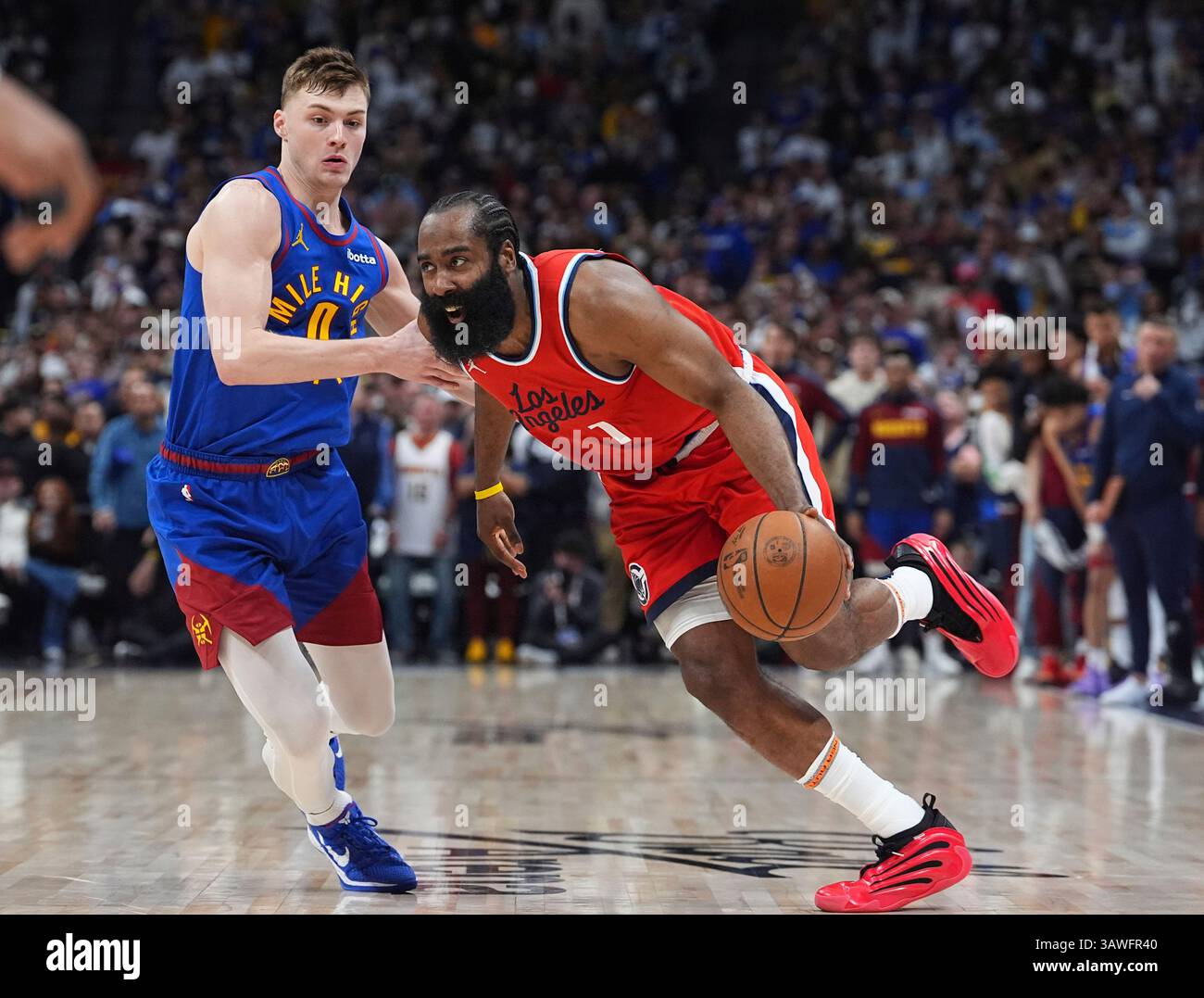 Los Angeles Clippers guard James Harden (1) drives past Denver Nuggets ...