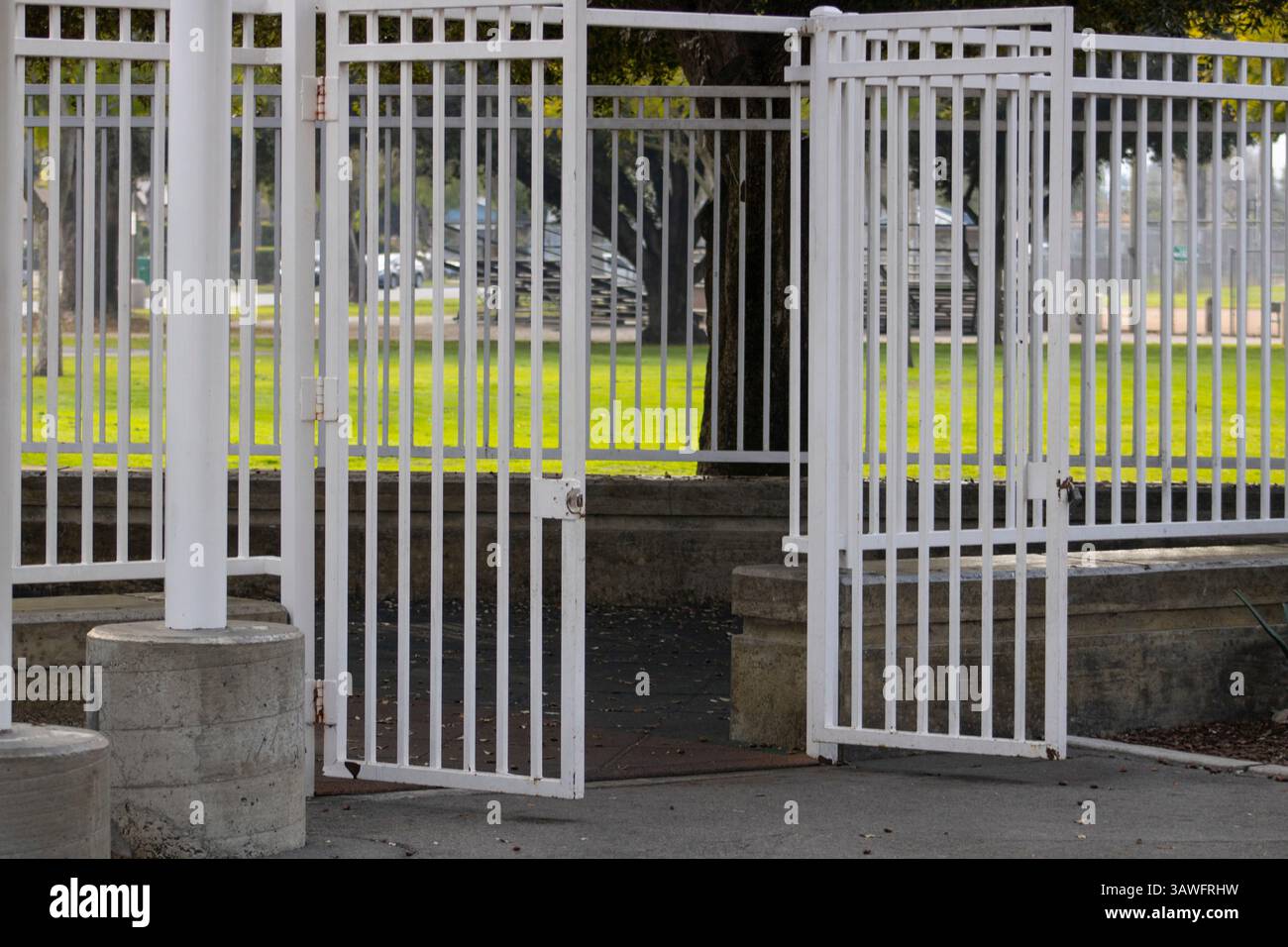 white metal gate with open door Stock Photo - Alamy