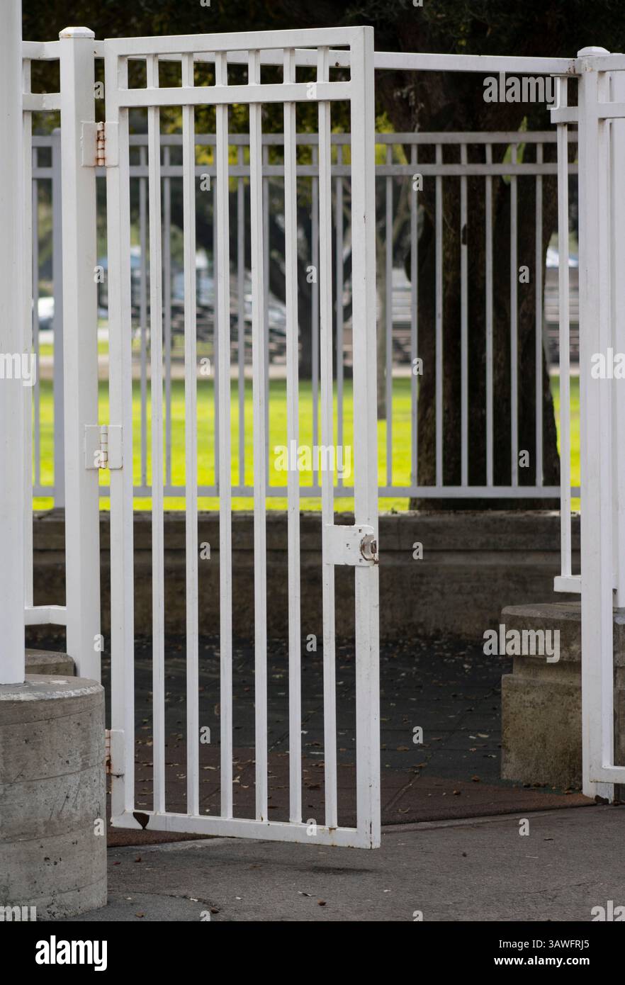 white metal gate with open door Stock Photo - Alamy