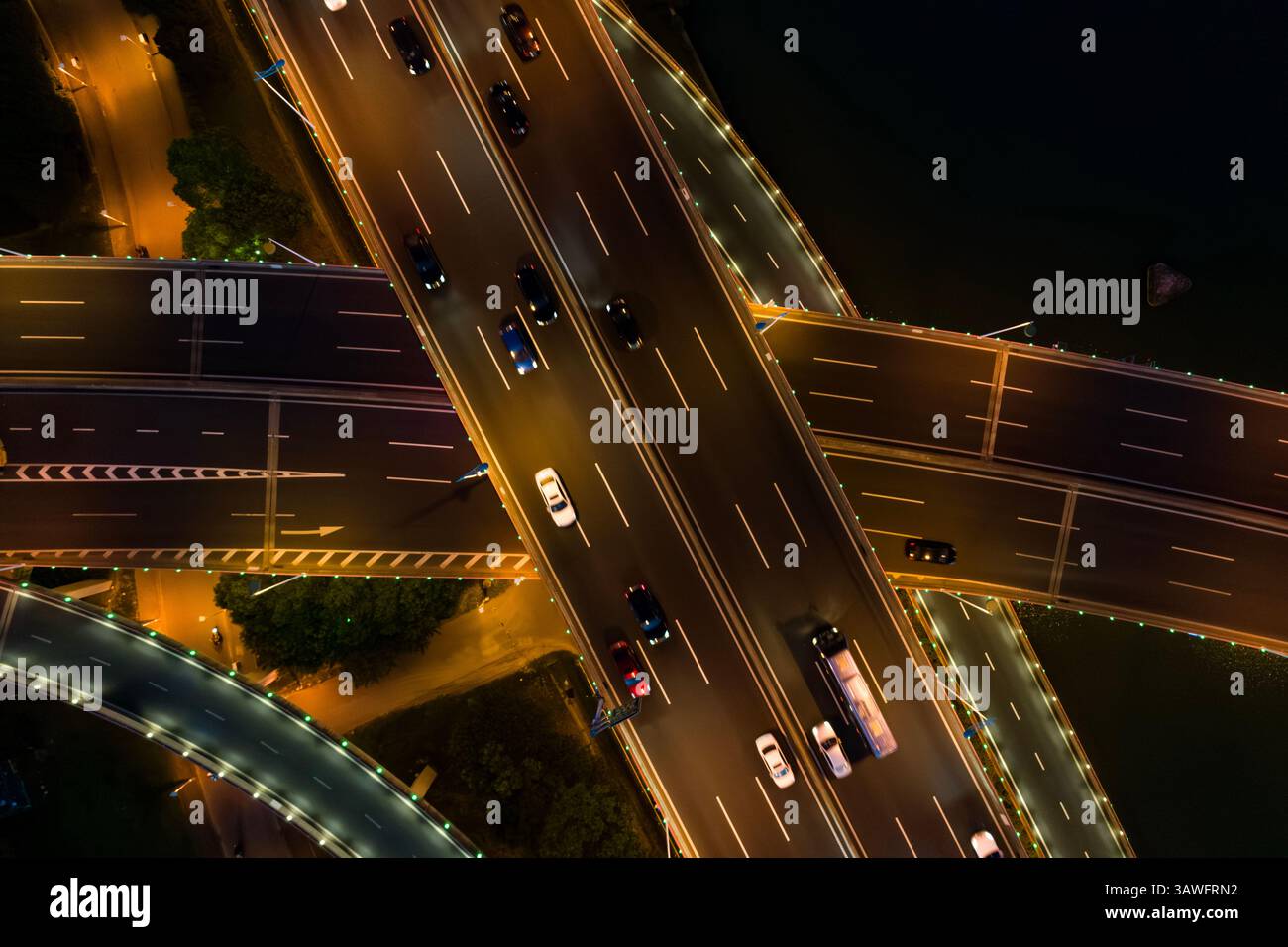 Aerial view of a busy road junction during nighttime with illuminated ...