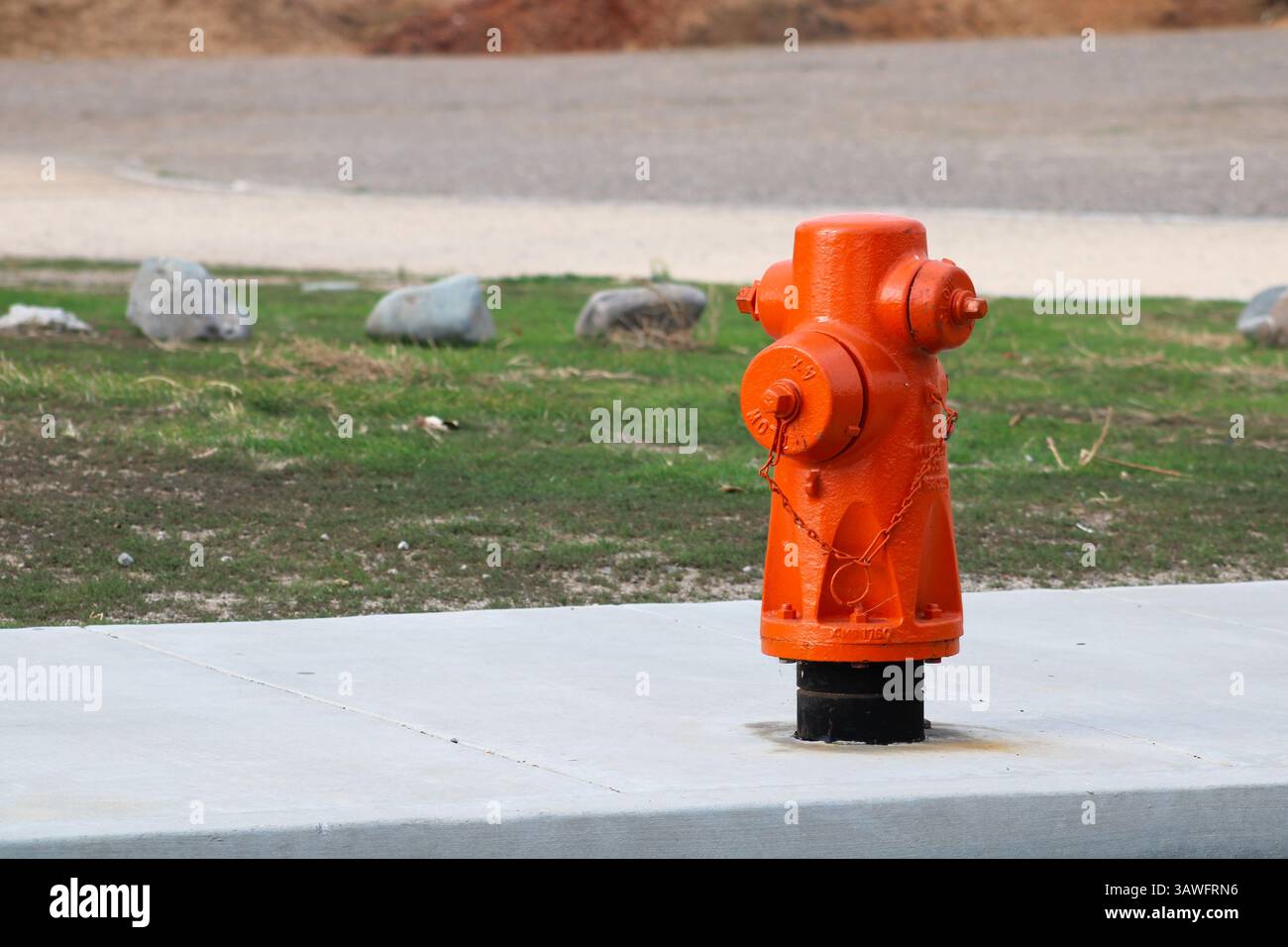 orange fire hydrant on sidewalk Stock Photo - Alamy