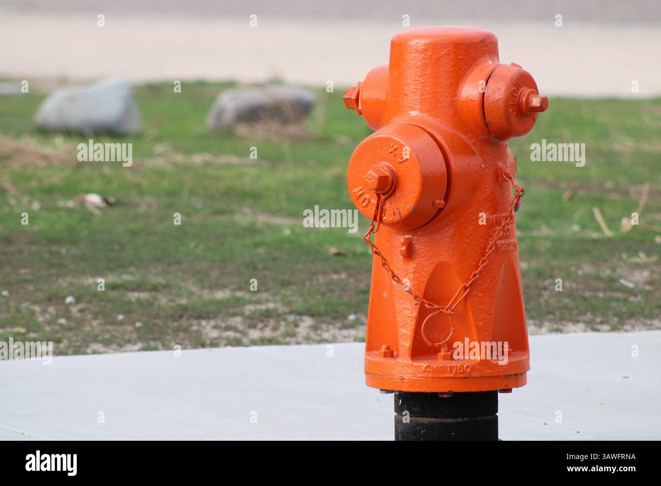 orange fire hydrant on sidewalk Stock Photo - Alamy