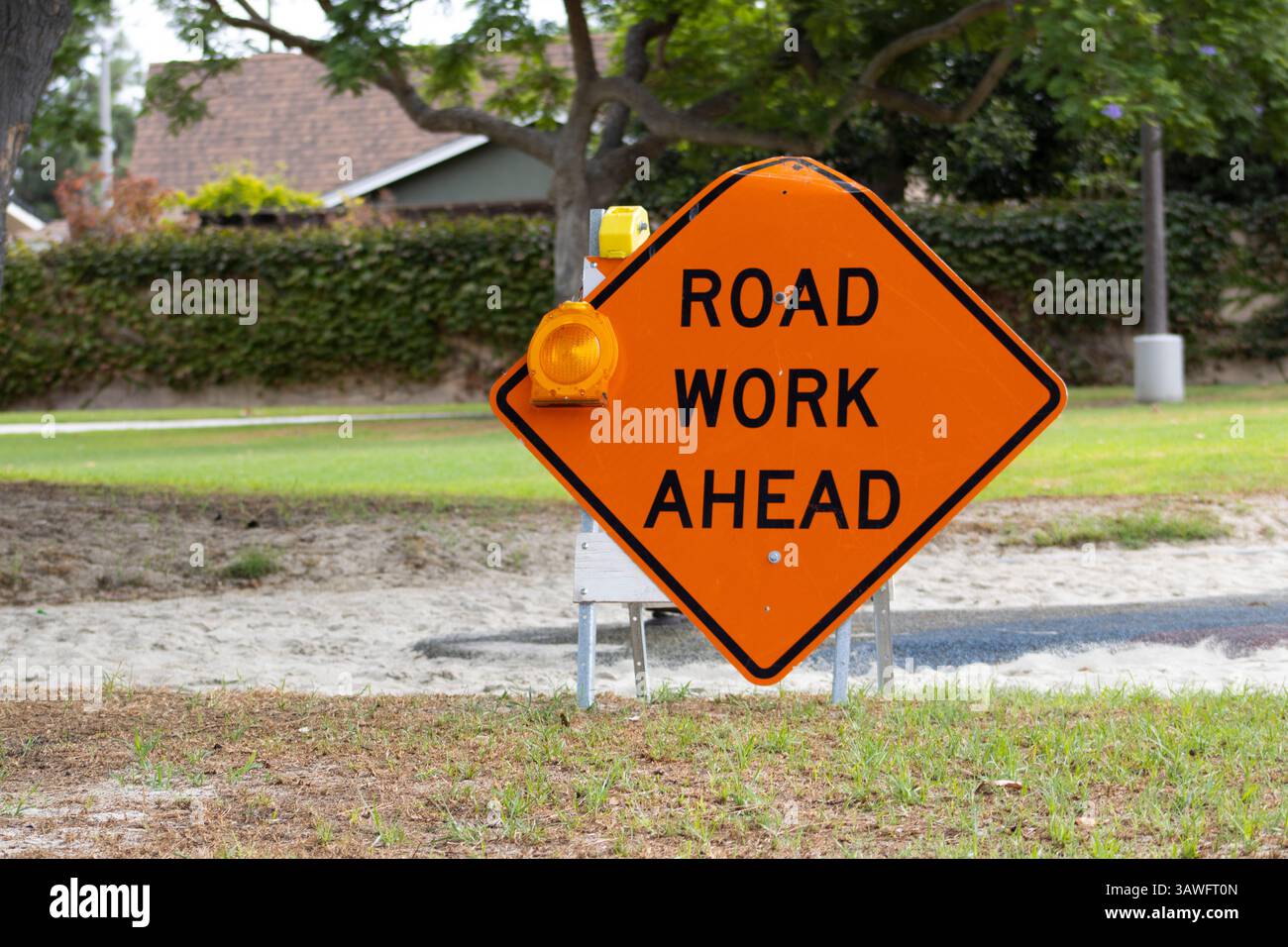 orange road work ahead sign Stock Photo - Alamy