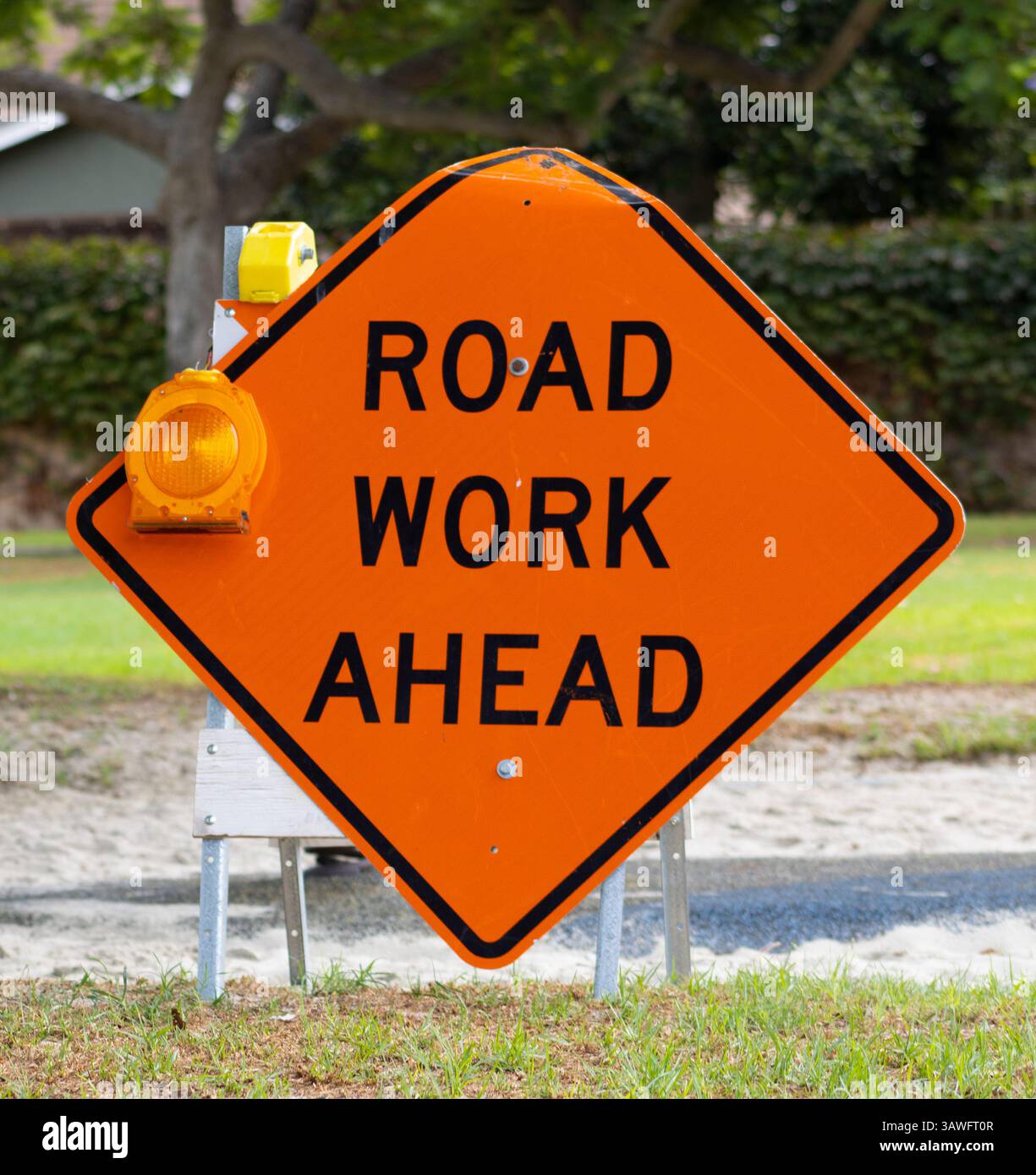 orange road work ahead sign Stock Photo - Alamy