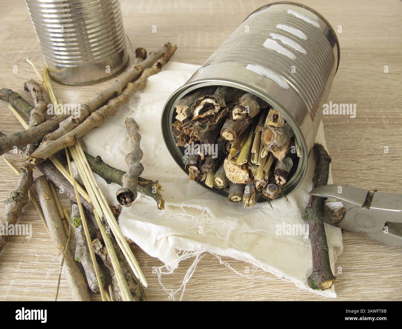 Homemade insect hotel made from tins, sticks and straw Stock Photo - Alamy