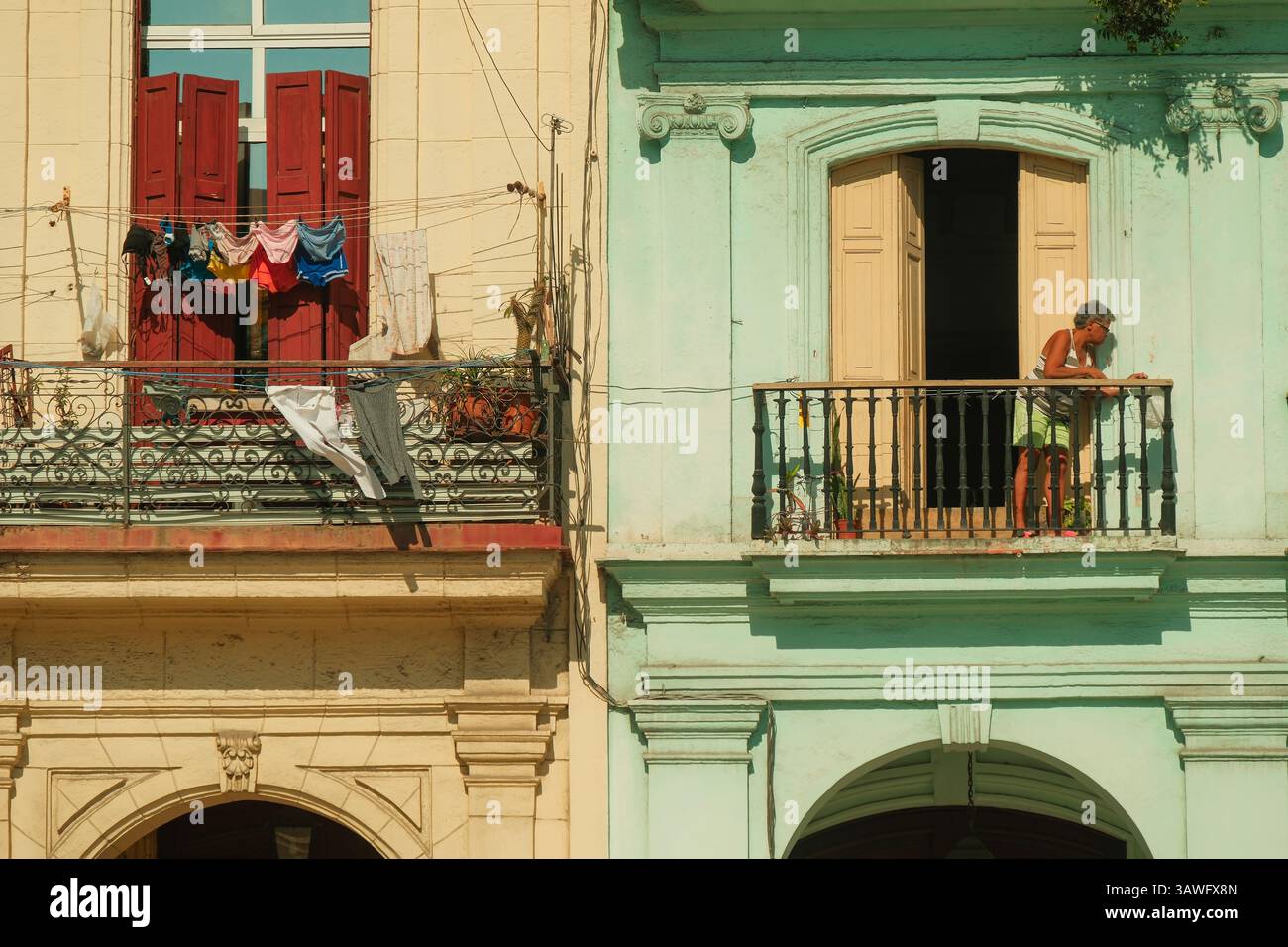 Havana, Cuba 2024 Apr14 - A Cuban woman fixing her laundry line on her ...