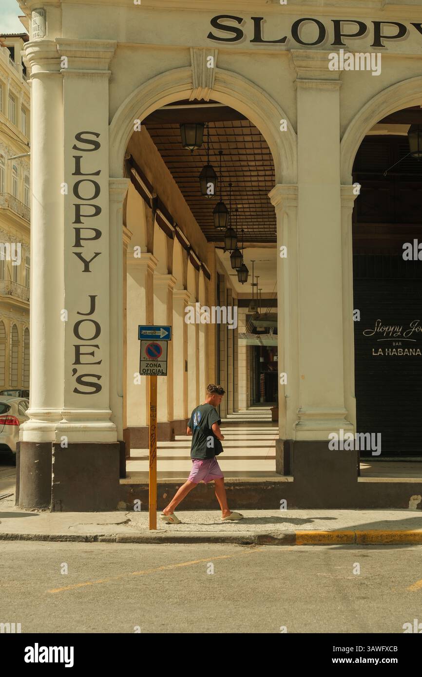 Havana, Cuba 2024 Apr17 - A man walks past the iconic Sloppy Joe’s Bar. This historic bar in a ...