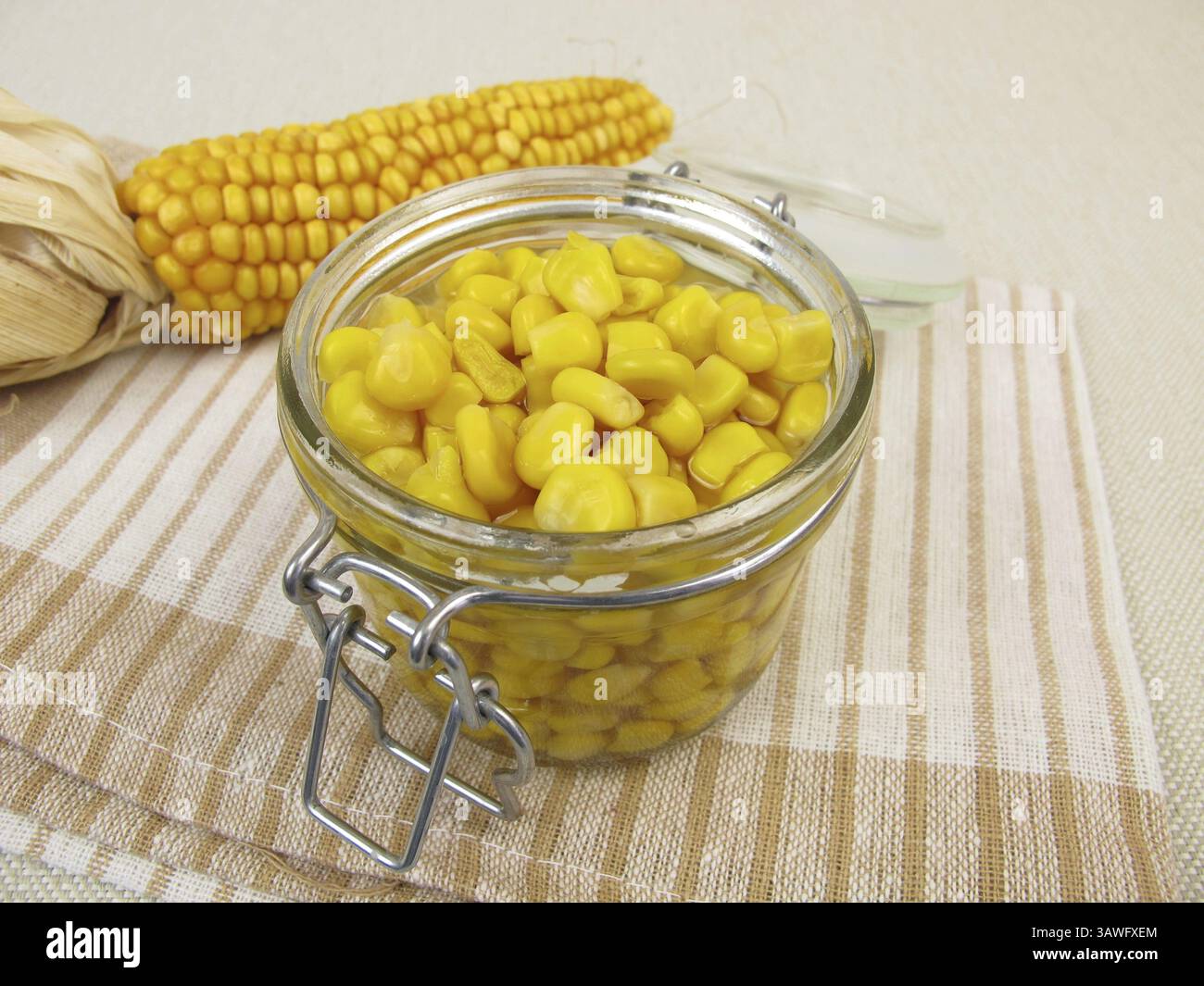 Cooked corn kernels in a jar Stock Photo - Alamy