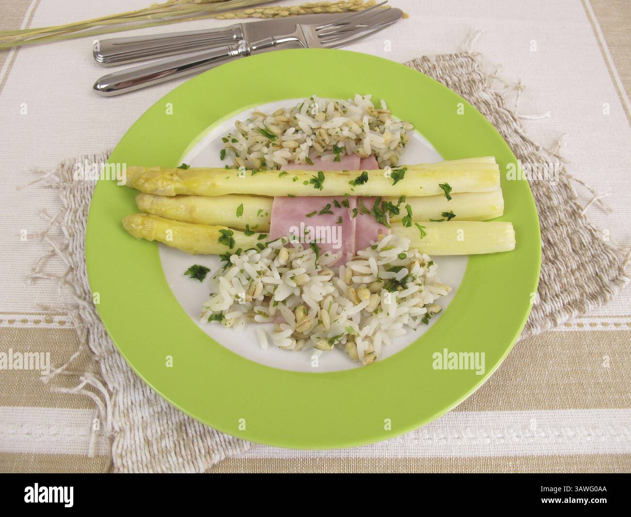 Roasted asparagus with herb rice, barley and ham Stock Photo - Alamy