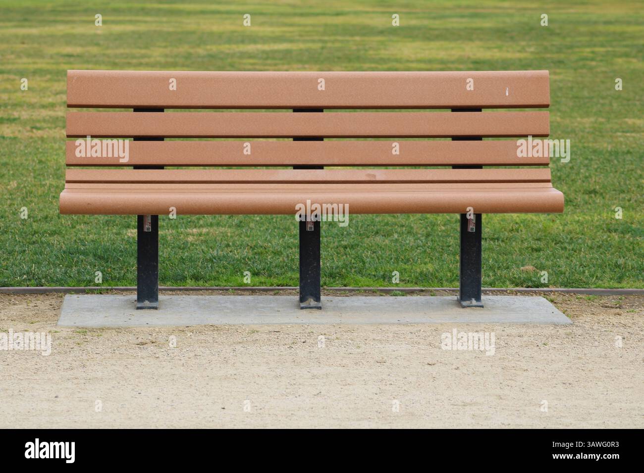 brown park bench near grass Stock Photo - Alamy