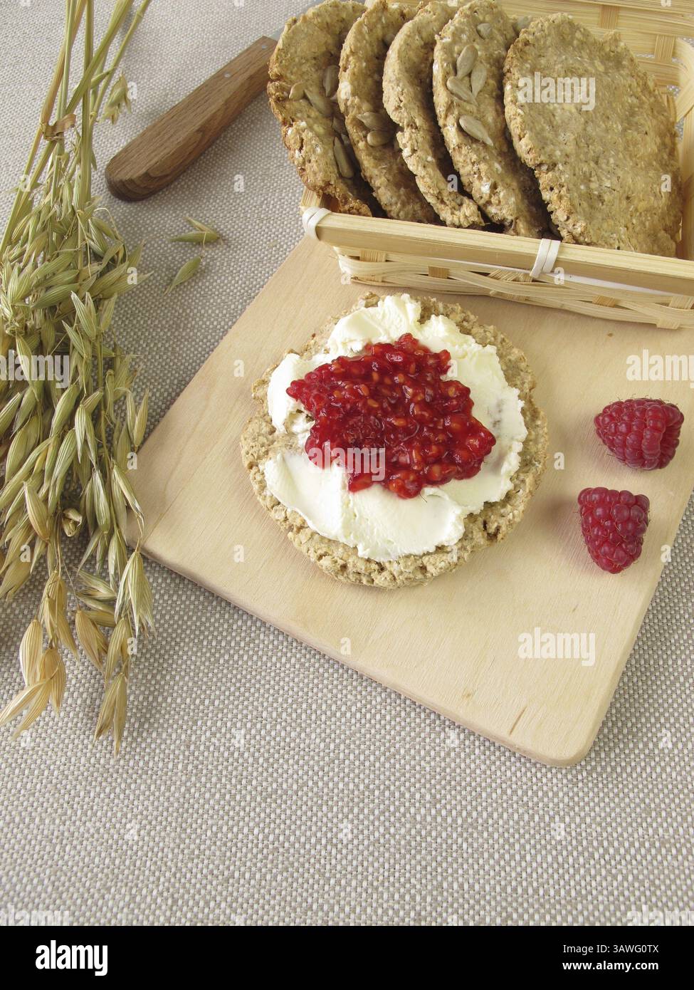 Round oat crispbread with raspberry cream cheese Stock Photo - Alamy
