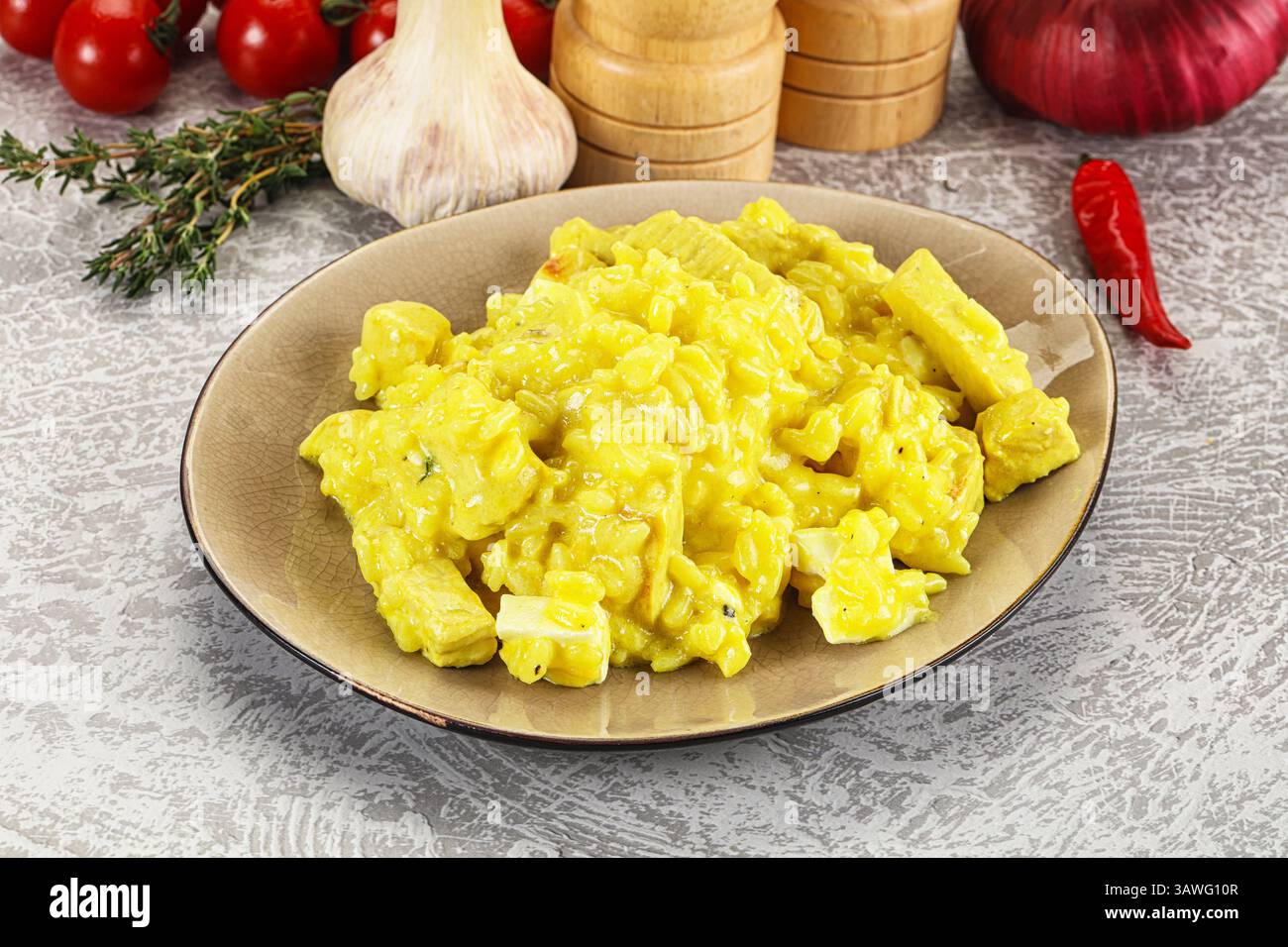 Italian cuisine - yellow risotto with chicken and soft cheese Stock ...