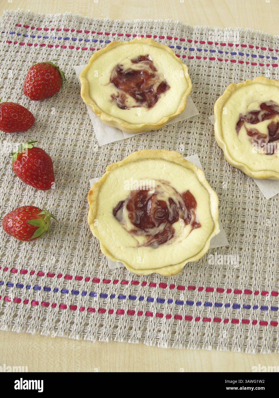 Small quark cakes with strawberry jam Stock Photo - Alamy