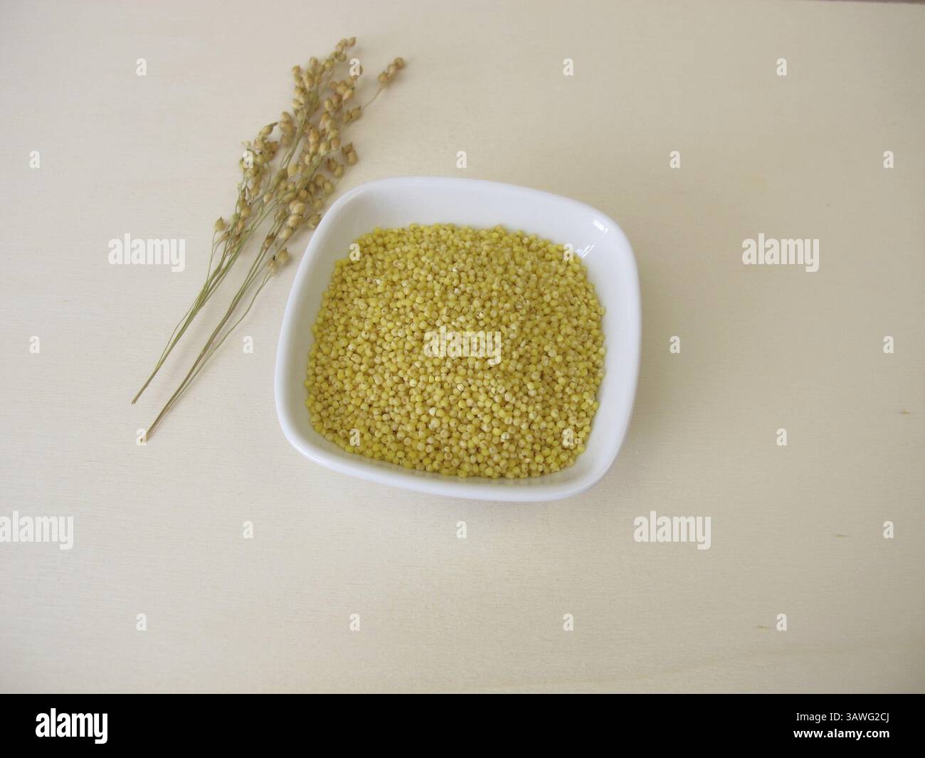 Fine-grained millet on a wooden board Stock Photo - Alamy