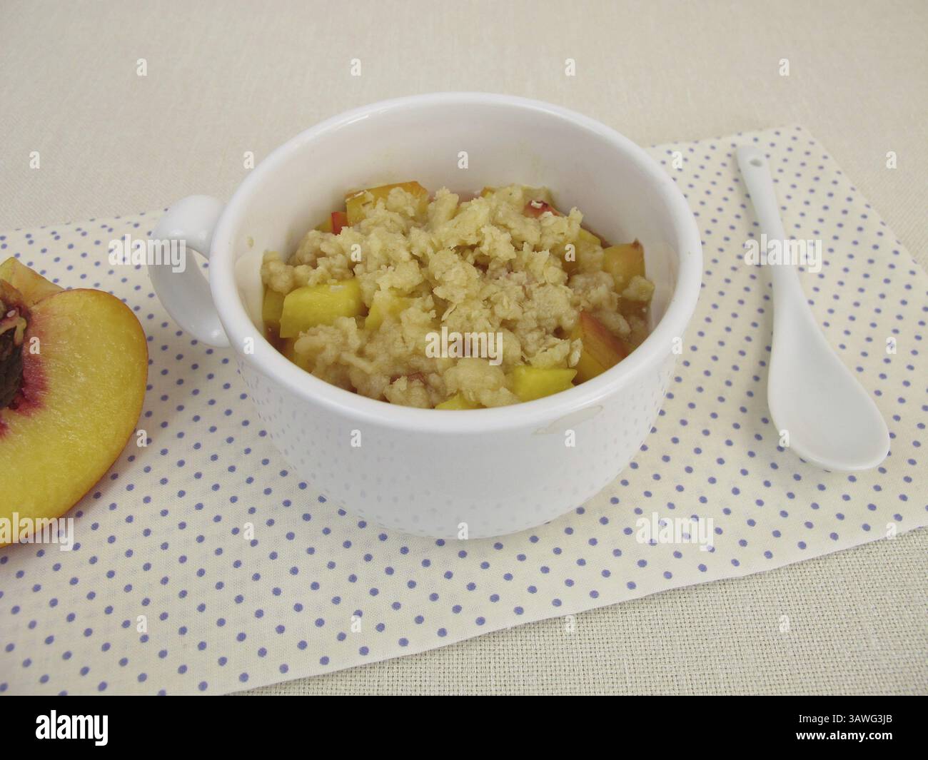 Crumble mug cake with peach Stock Photo - Alamy