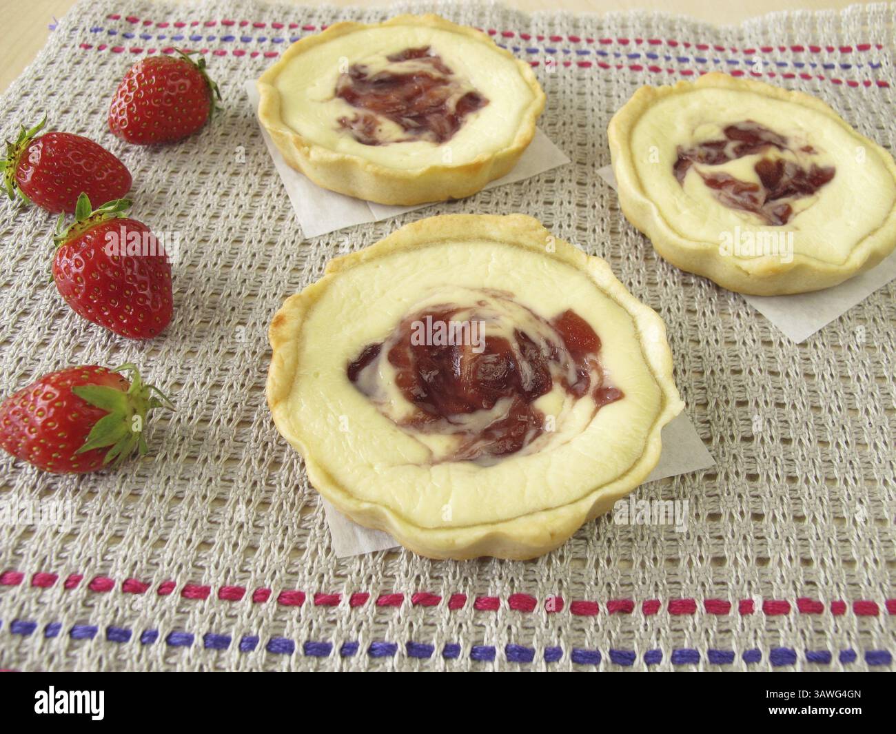 Small quark cakes with strawberry jam Stock Photo - Alamy