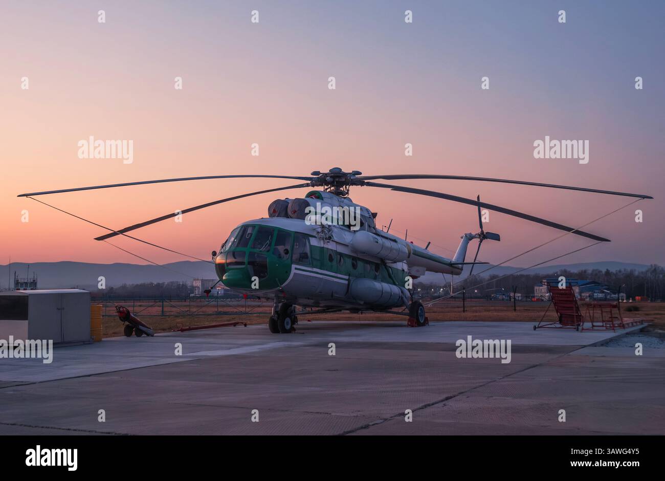 Helicopter on the runway during sunset at a regional airport in the ...
