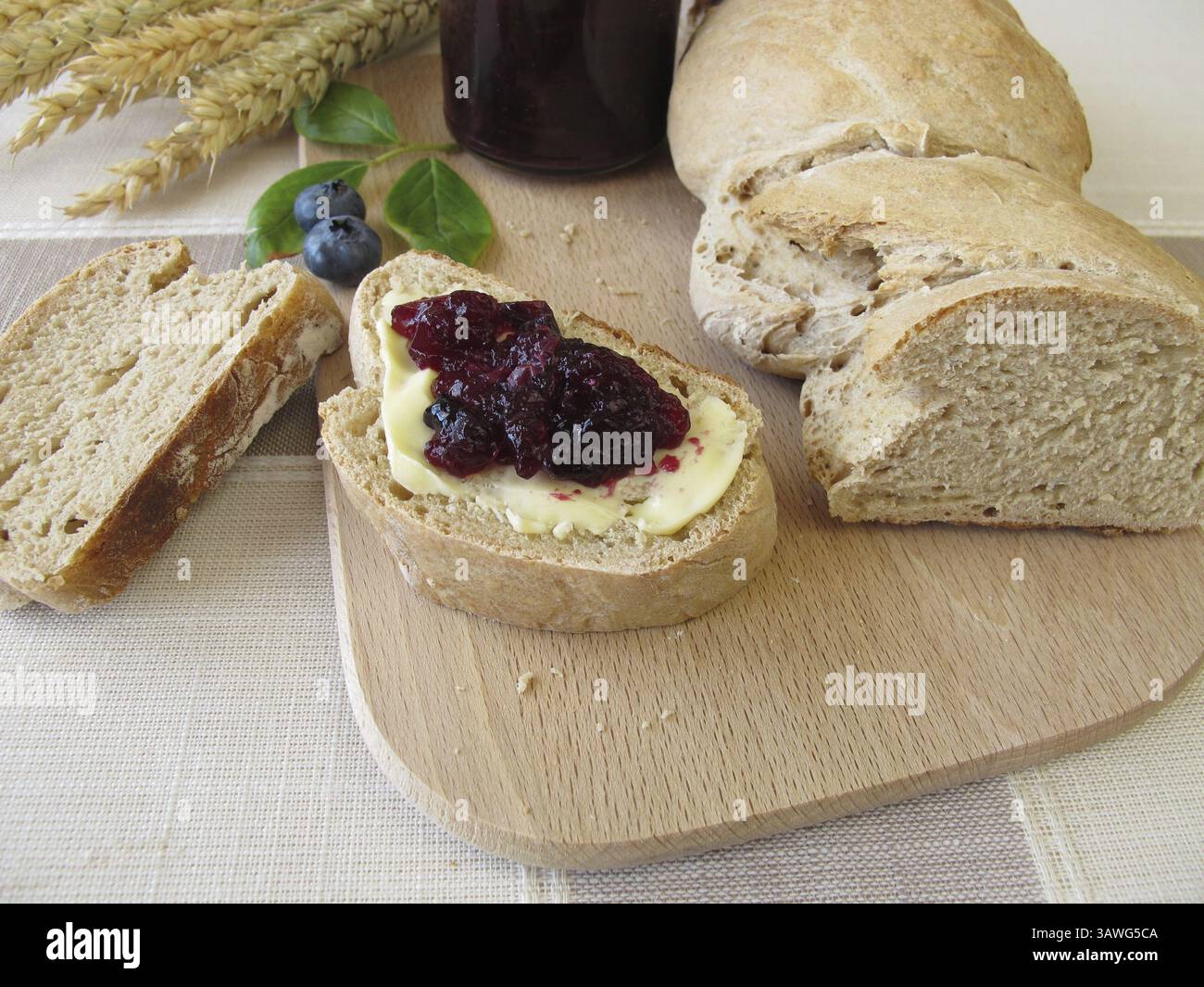 Blueberry jam on root bread for breakfast Stock Photo - Alamy