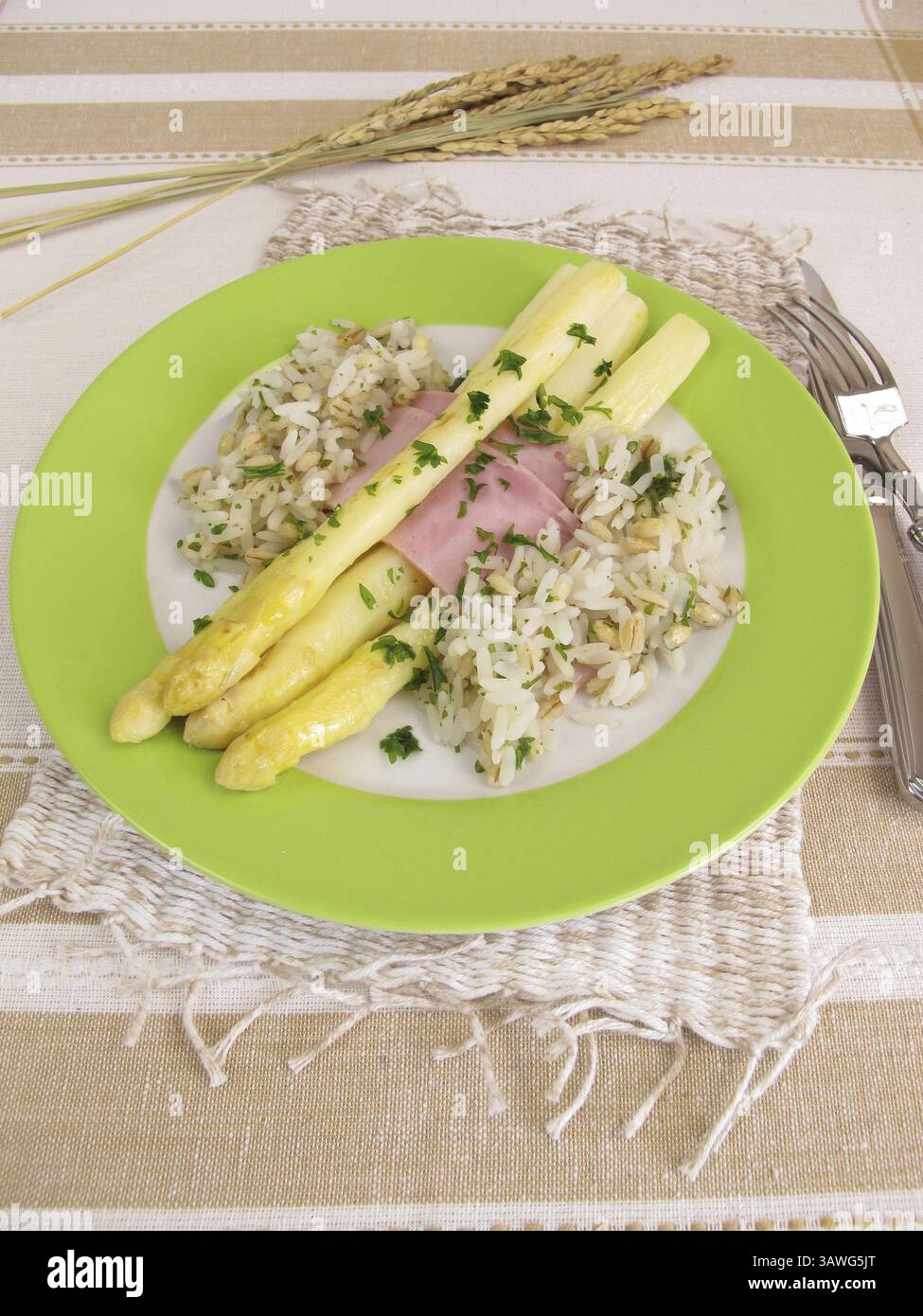 Roasted asparagus with herb rice, barley and ham Stock Photo - Alamy