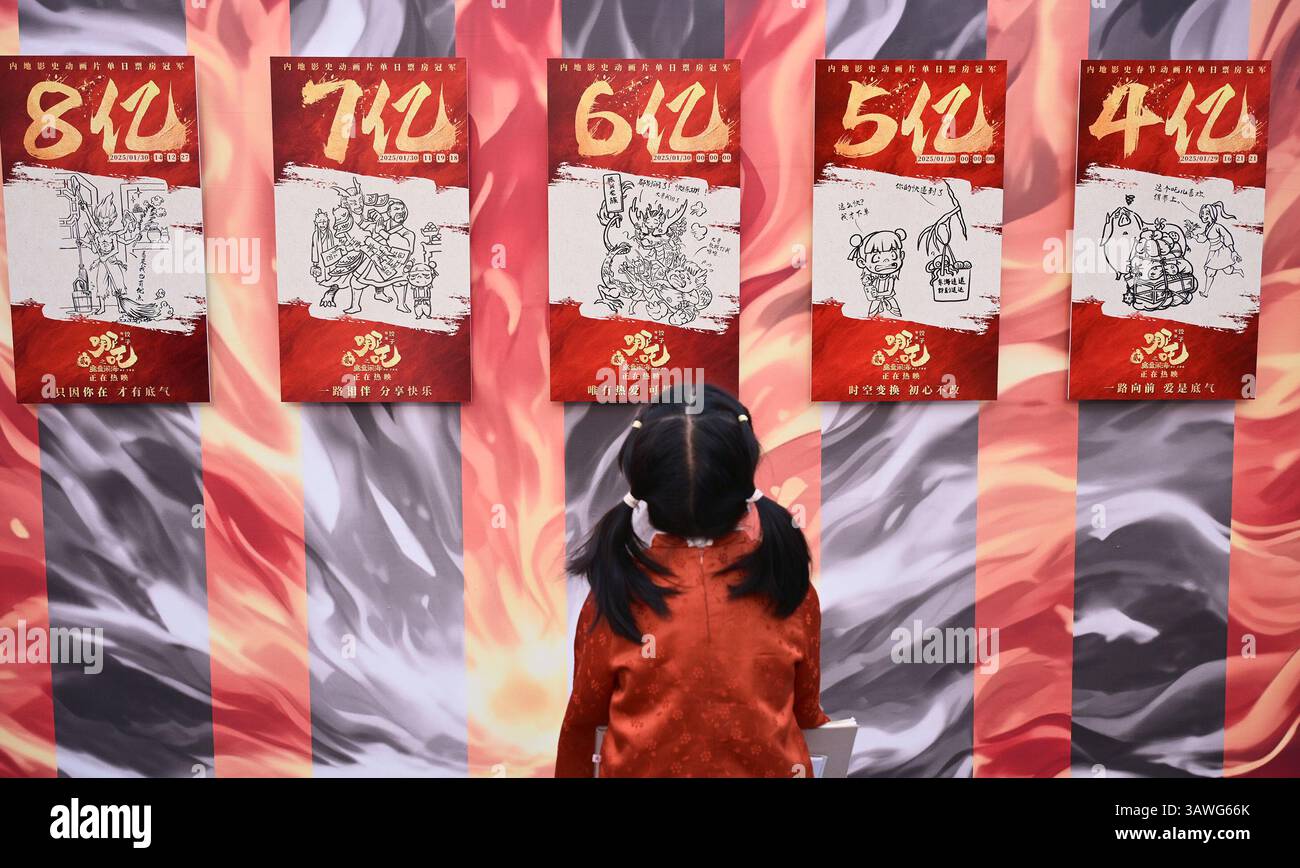 Beijing, China. 19th Apr, 2025. A girl views copies of hand-drawn ...