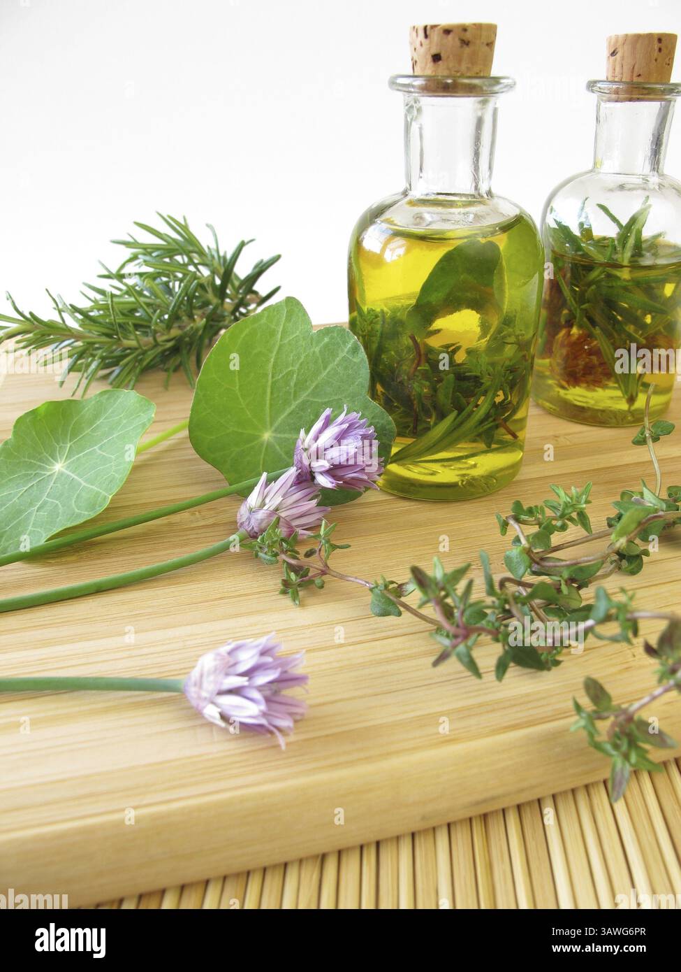 Homemade herb oil with chive blossom Stock Photo - Alamy