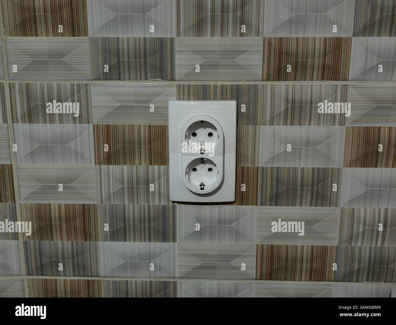 Double Power Socket in the Kitchen. Brown and white tiles , wall ...
