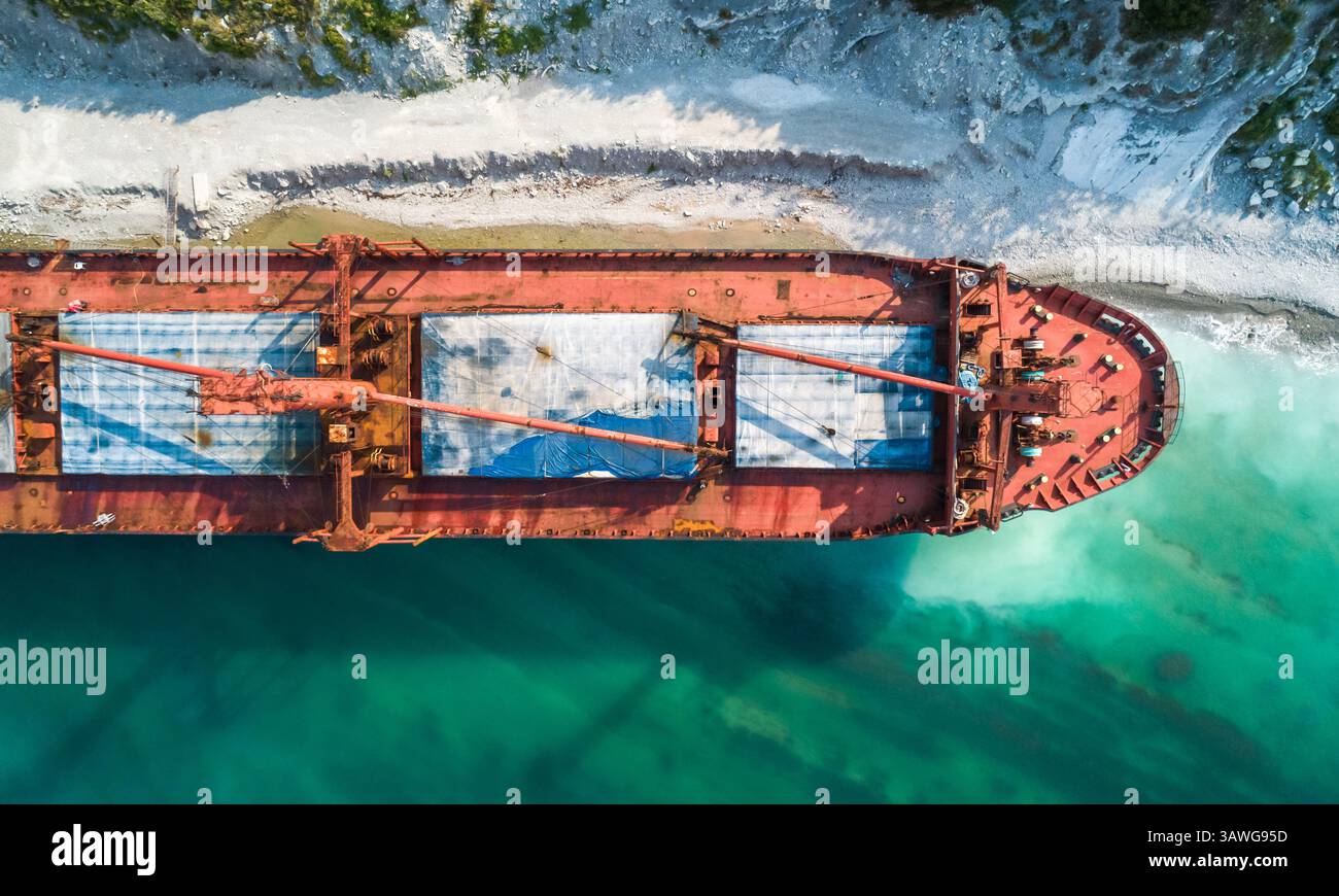 Aerial top down view of a bow part of an abandoned bulk-carrier dry ...
