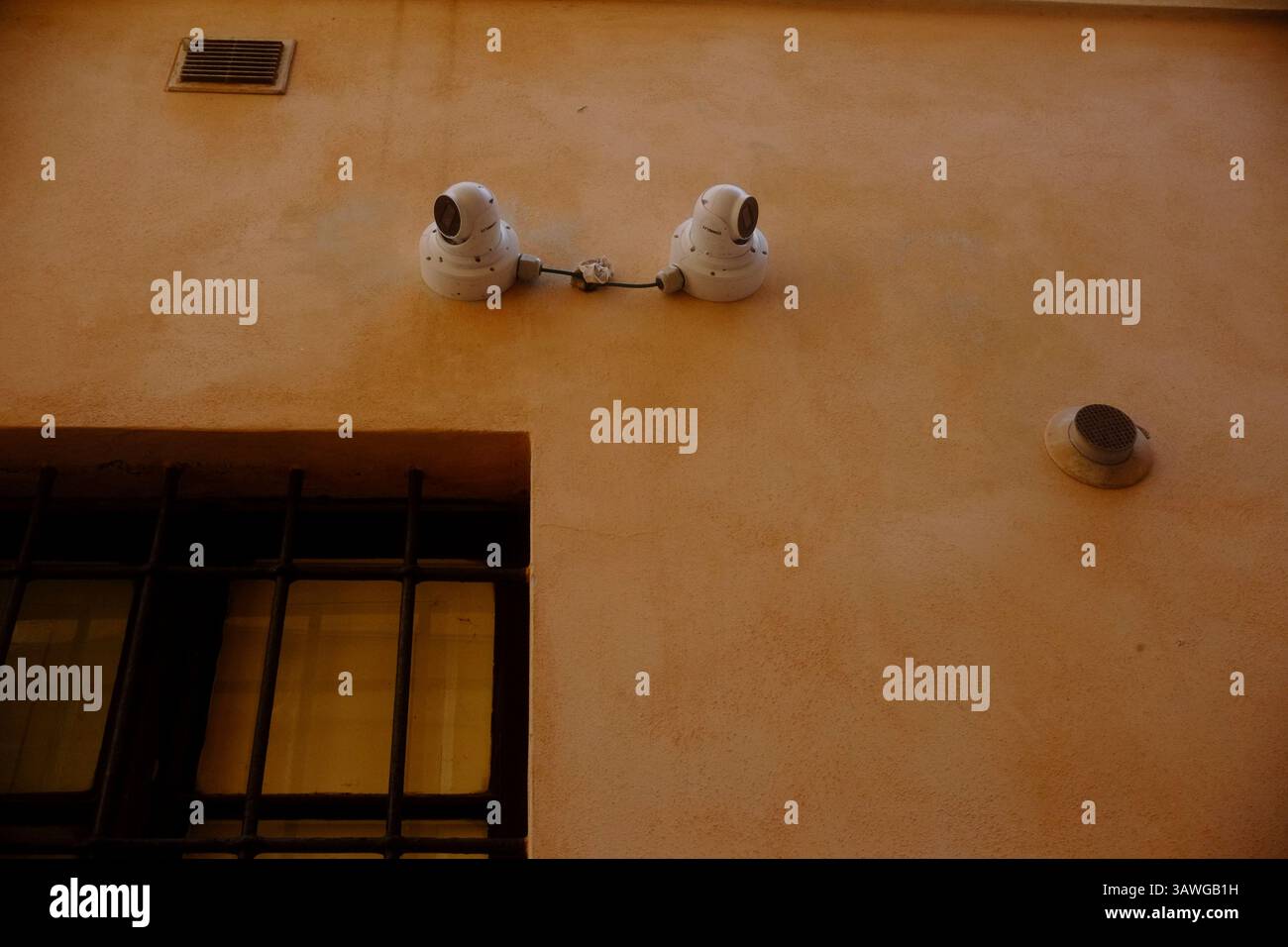 Cremona, Italy March 15th 2025 Two white security cameras are mounted ...